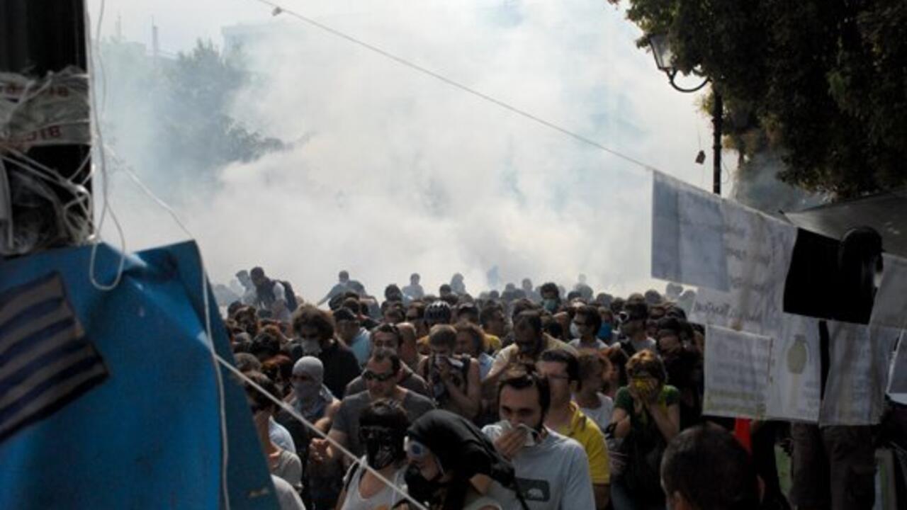Stuck between rioters and tear gas, Athens protesters hold their ground
